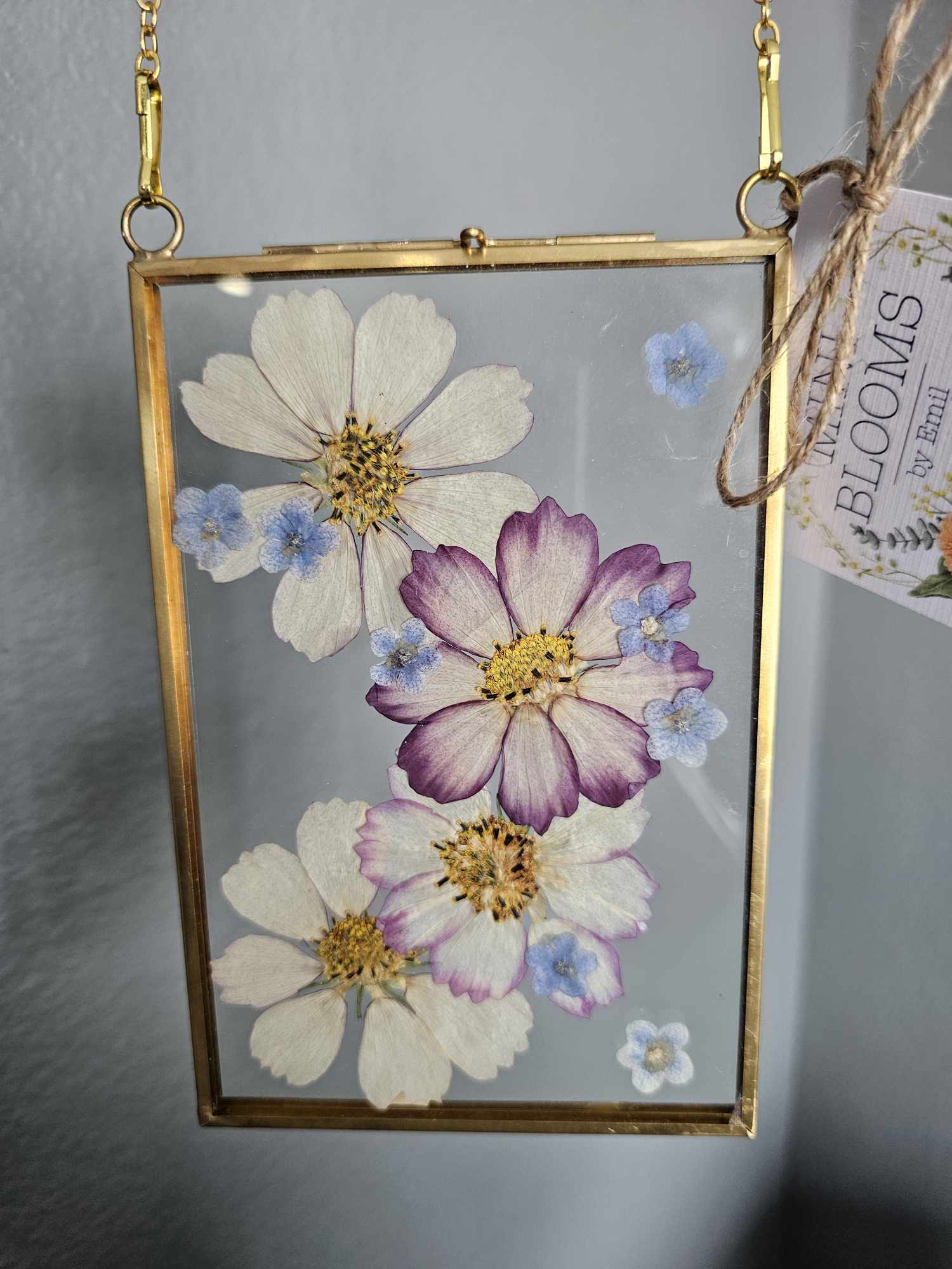 Vintage style gold frame with pressed pink, white, purple and blue flo ...